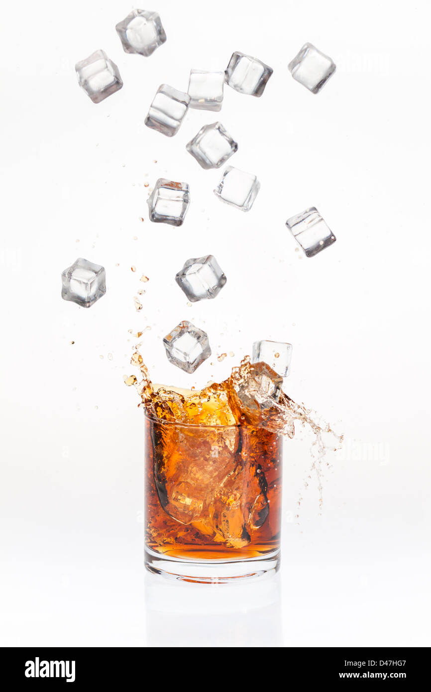 Ice cubes splashing bourbon Stock Photo - Alamy