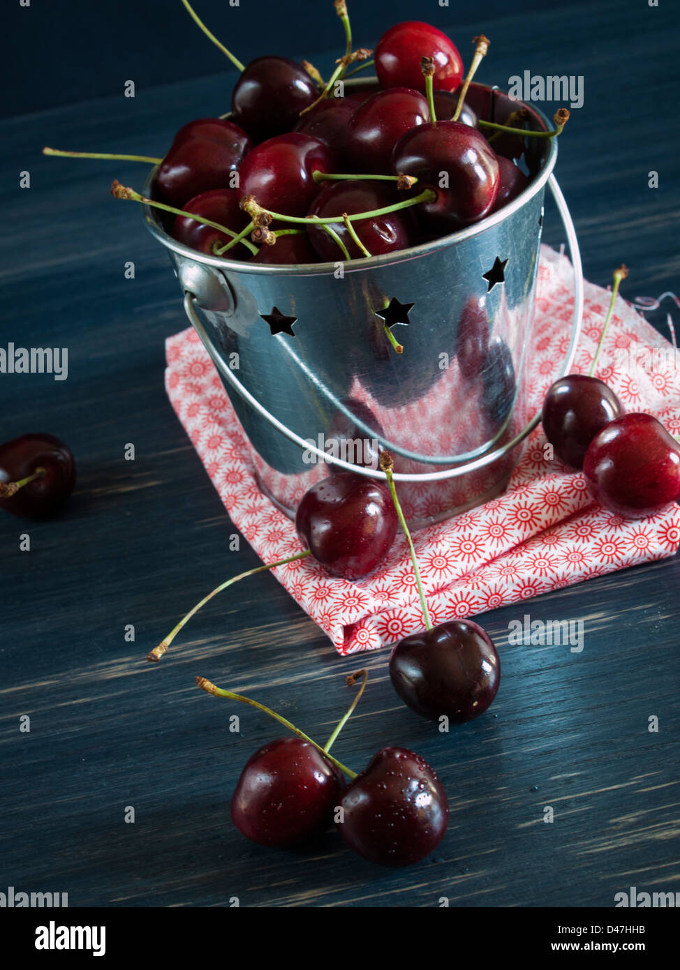 Freshly picked heap of cherries in metal bucket Stock Photo - Alamy