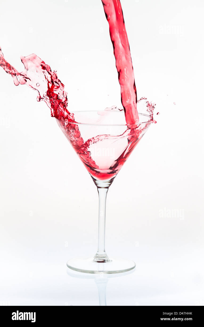 Blended drink splashing into cocktail glass Stock Photo - Alamy
