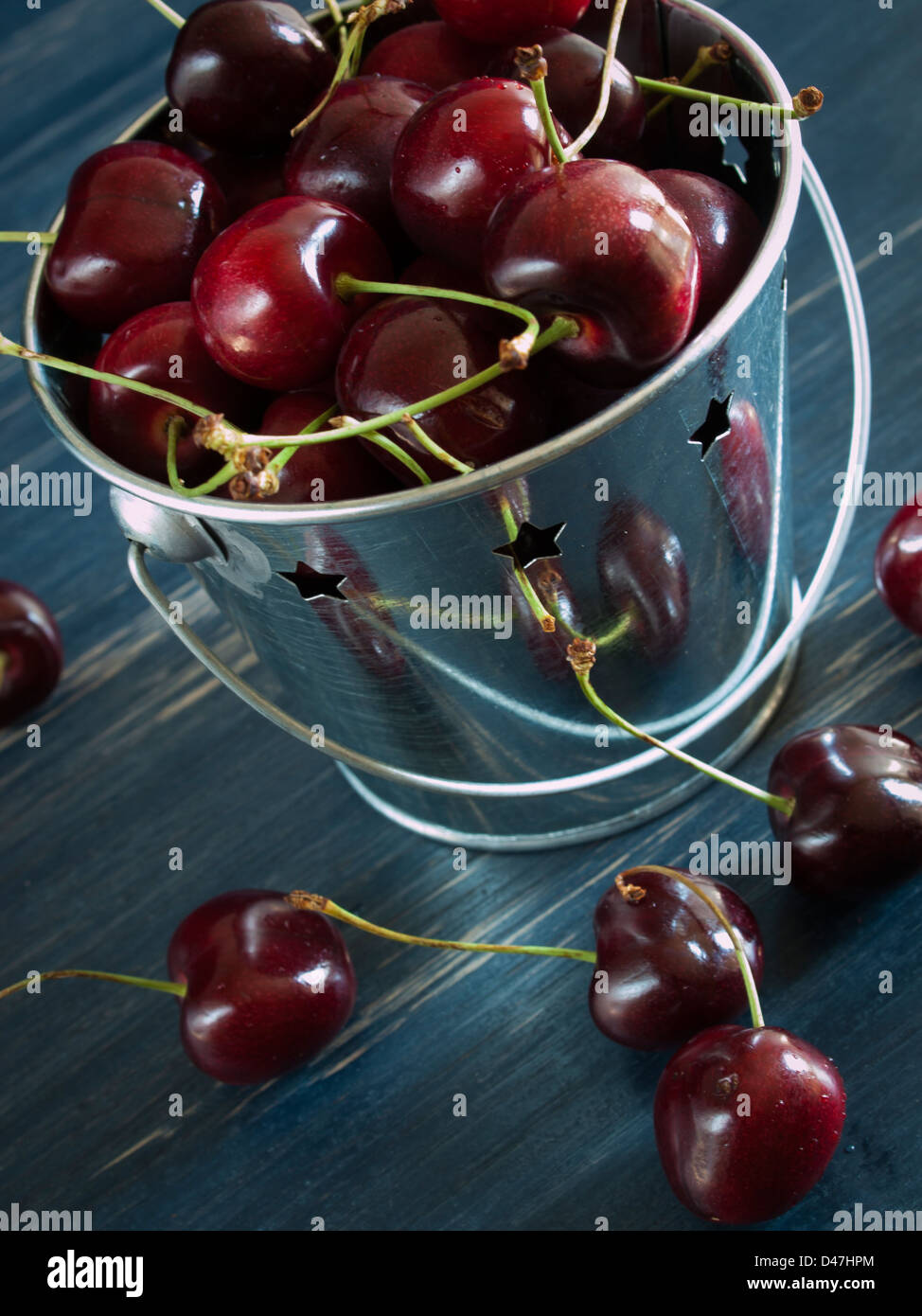 Freshly picked heap of cherries in metal bucket Stock Photo - Alamy