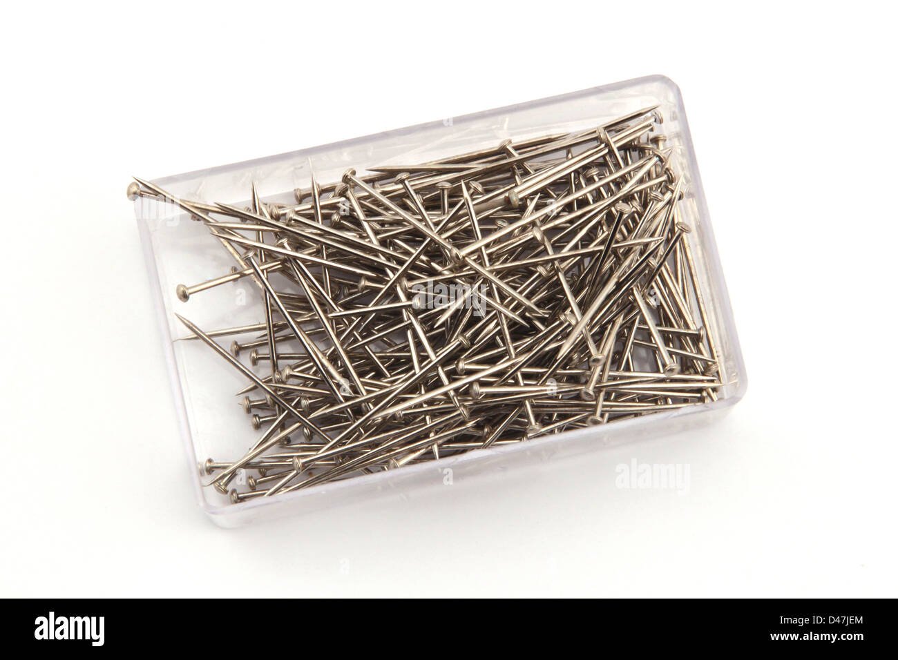 Pin used when sewing on a white background Stock Photo - Alamy