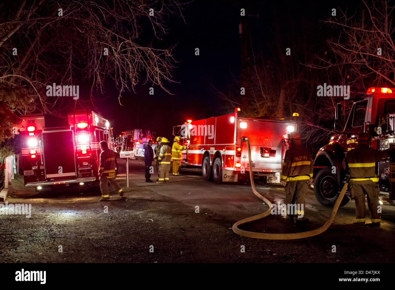 Firefighters monitoring the gauges on a Water Tender Truck at a house ...