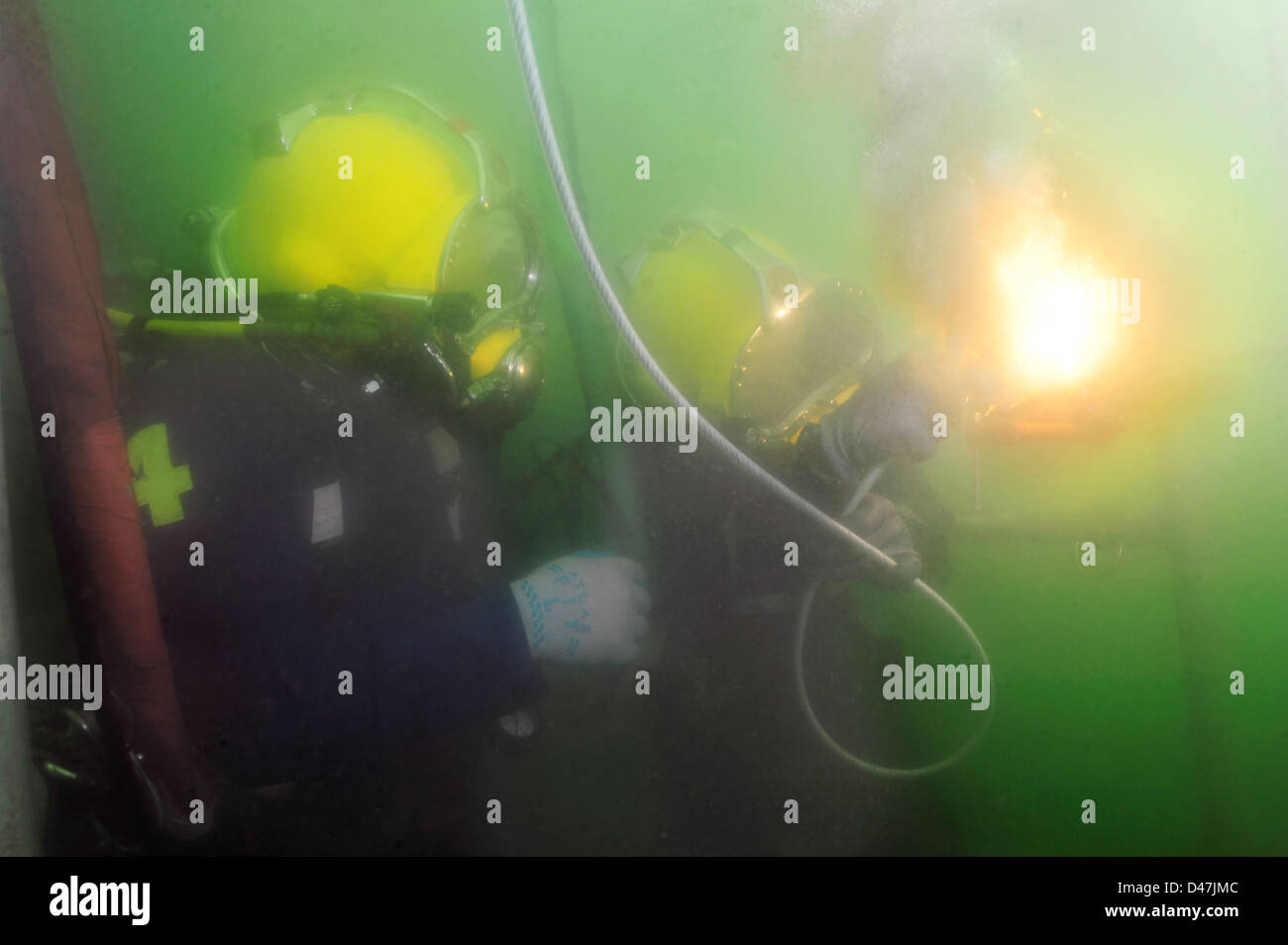 Navy Diver 1st Class Brian Mouton works alongside a Colombian diver to ...