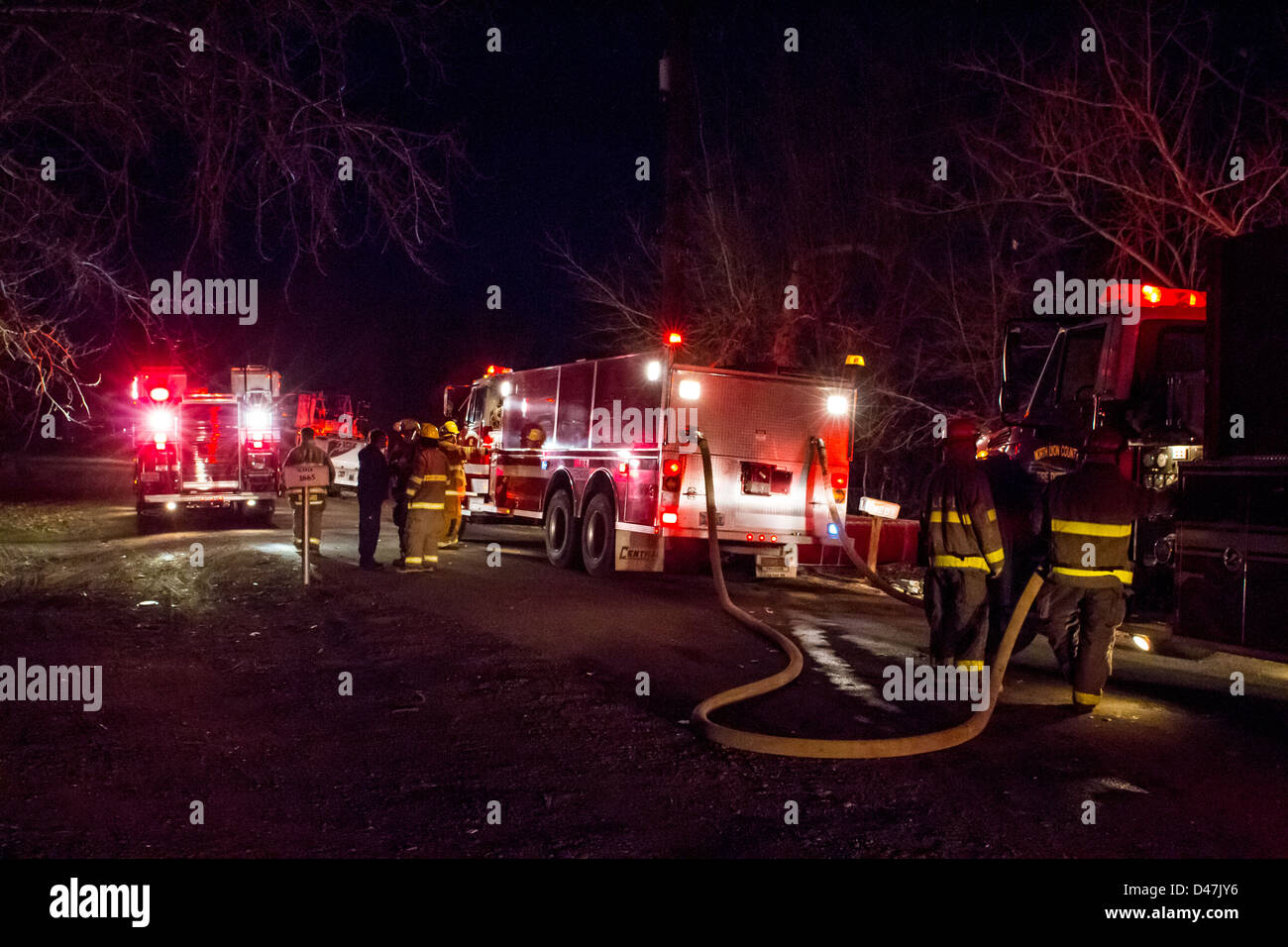 Firefighters monitoring the gauges on a Water Tender Truck at a house ...