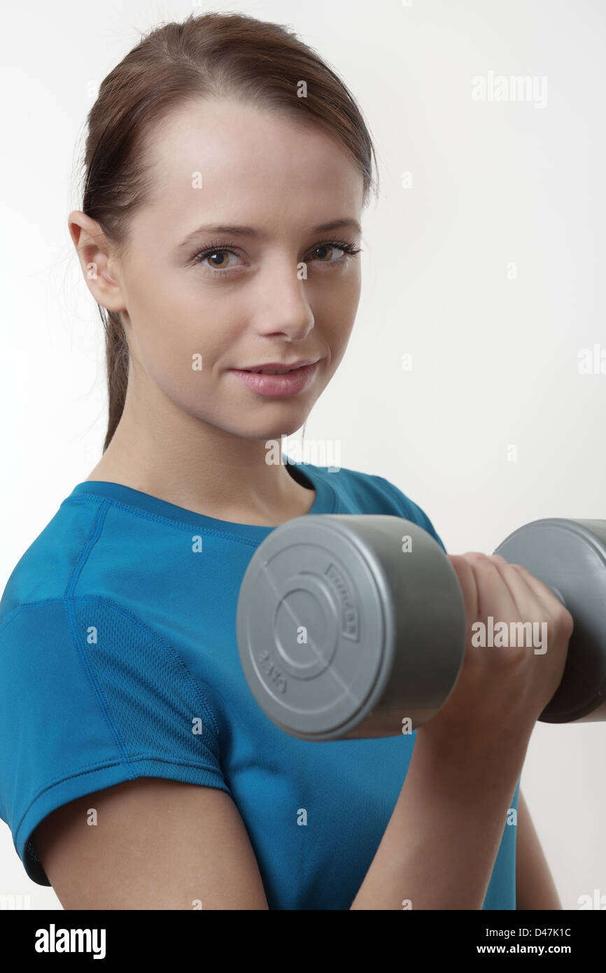 attractive woman doing a workout routine with a dumbbell weights Stock ...