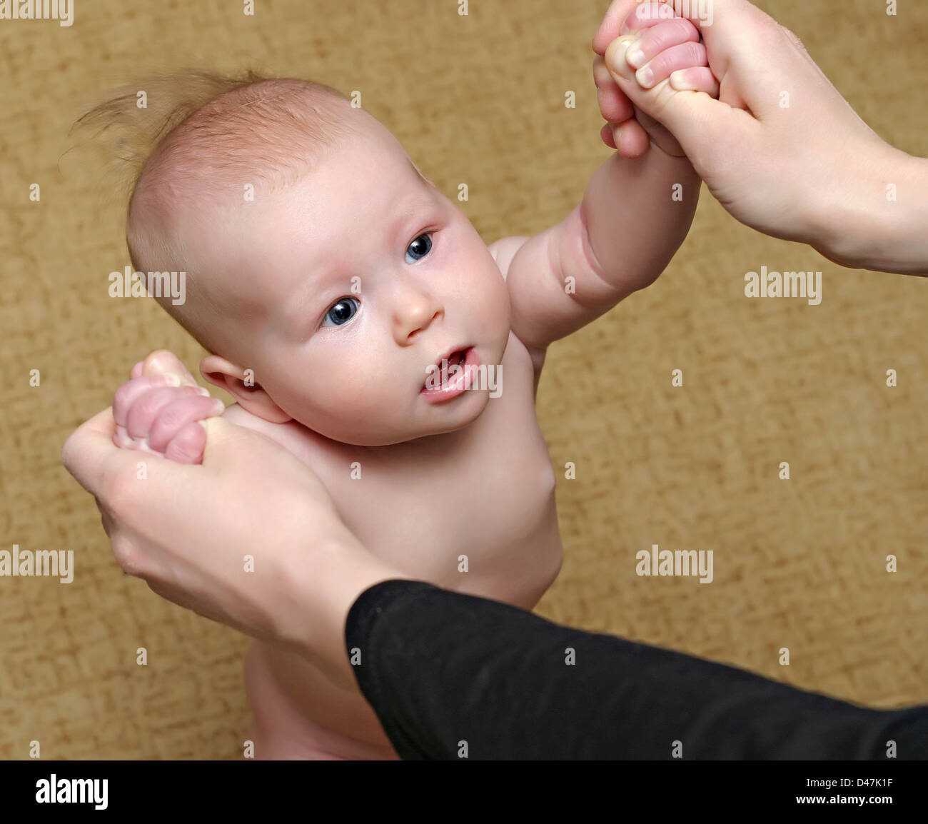 Newborn baby stand with her mother help Stock Photo - Alamy