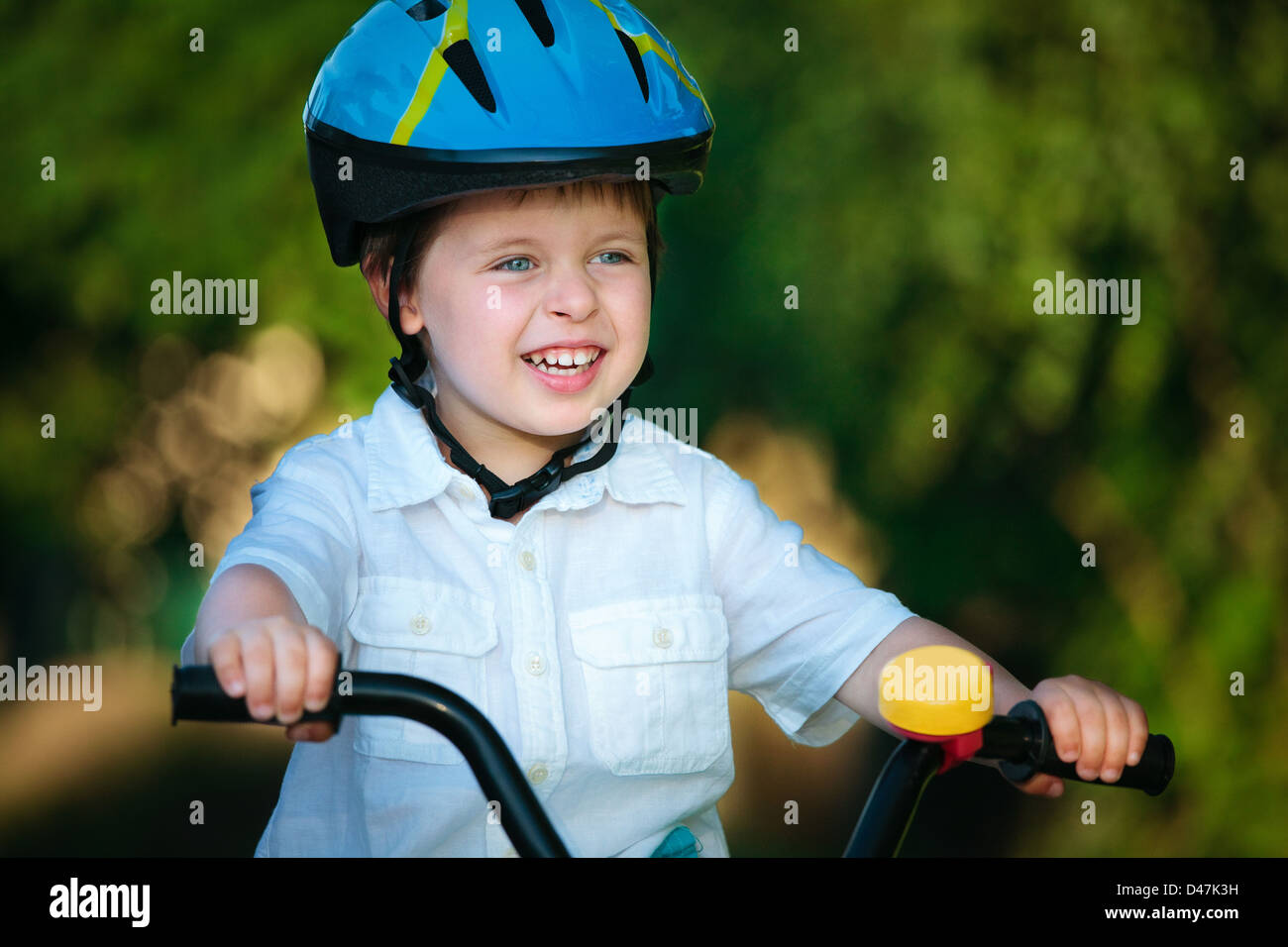 Portrait of a cute little boy in a bicycle Stock Photo - Alamy