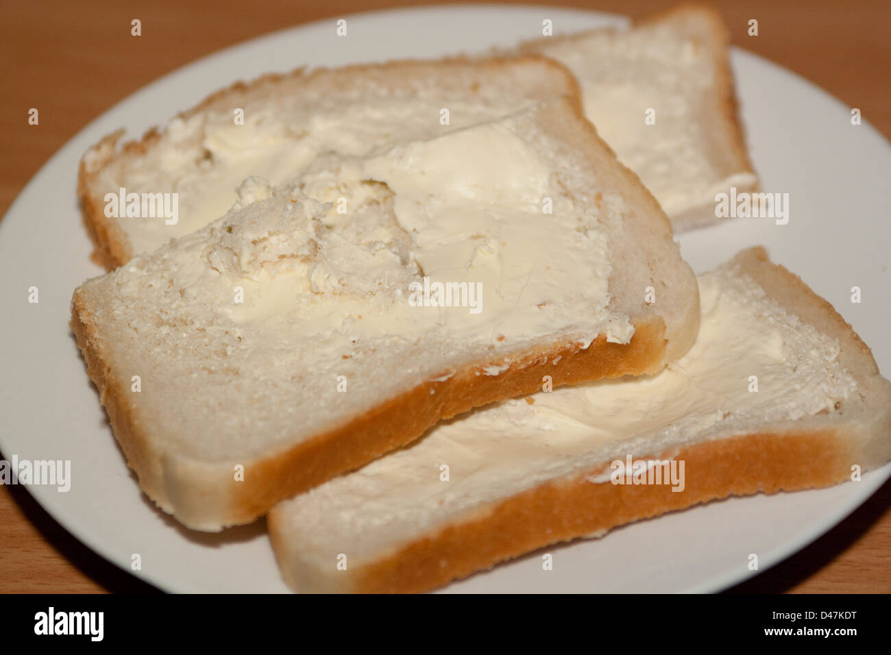Bread and butter on plate Stock Photo - Alamy