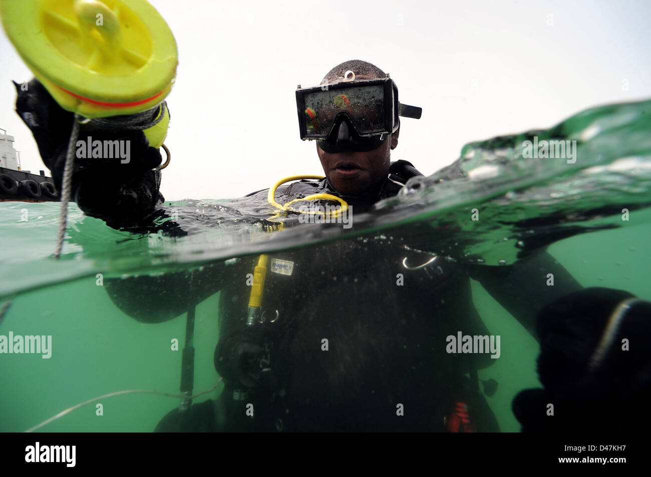 A U.S. Navy diver performs underwater operations off the coast of ...