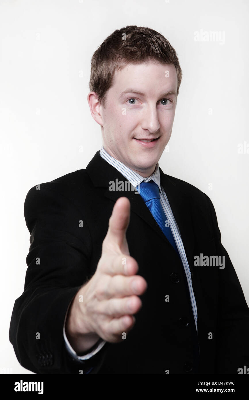 business man in a suit about to shake your hand and close the deal ...