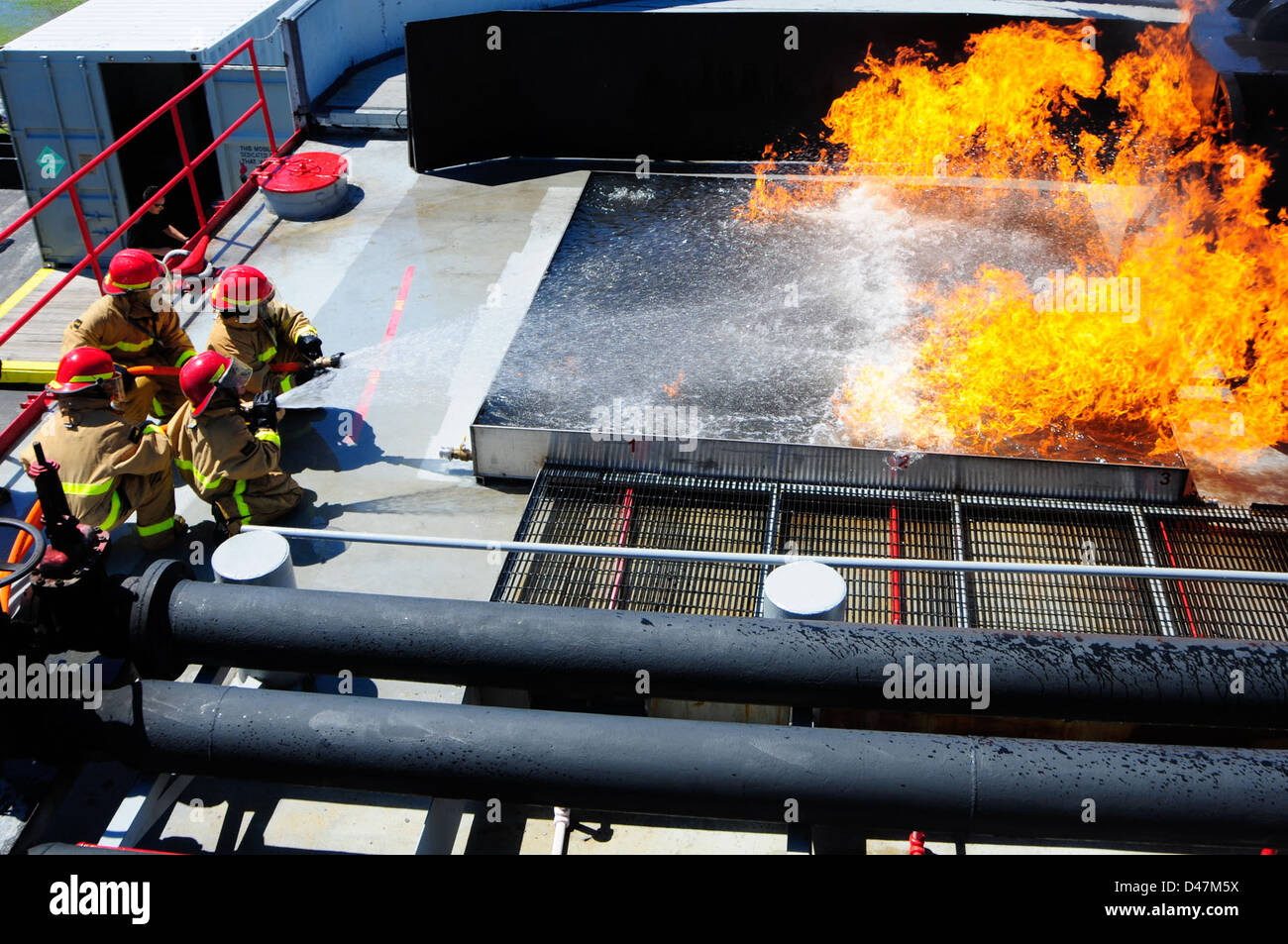 Sailors aboard USS Wasp (LHD 1) work together during a P-100 fire ...