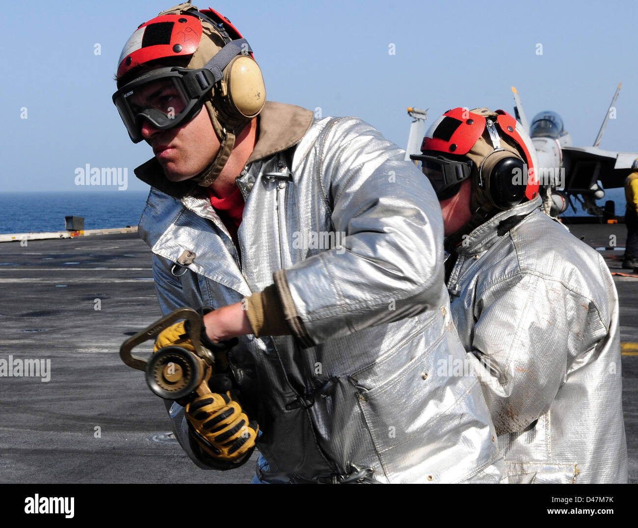 U.S. Navy crash and salvage team members respond to a simulated fire ...