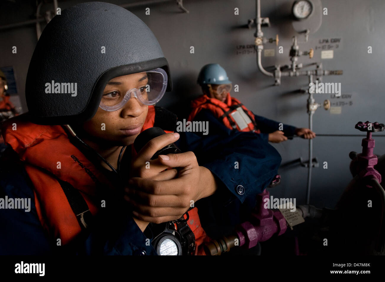A U.S. Navy Sailor aboard a ship in the Atlantic Ocean waits to receive ...