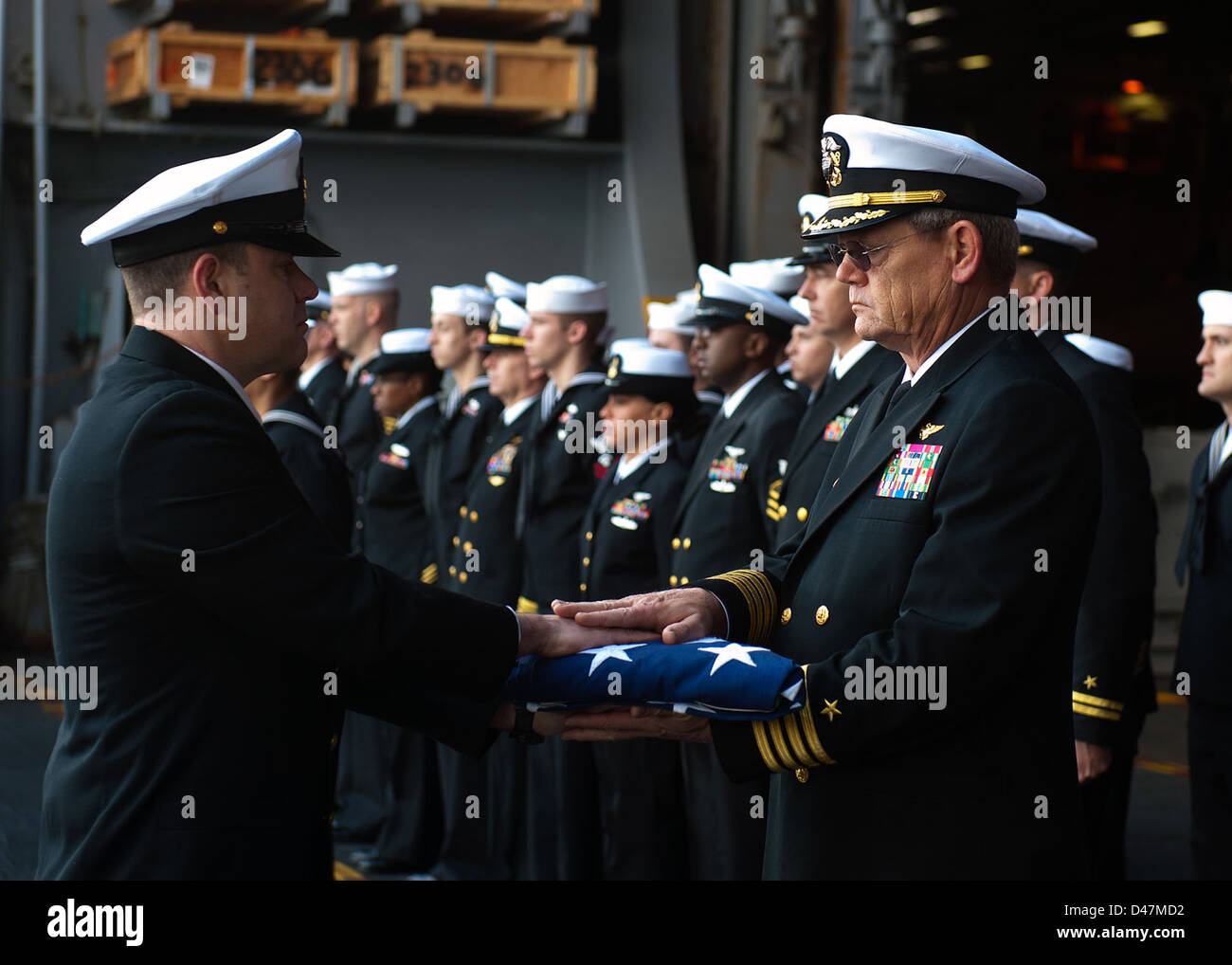 Sailors pass a flag during a burial at sea Stock Photo - Alamy
