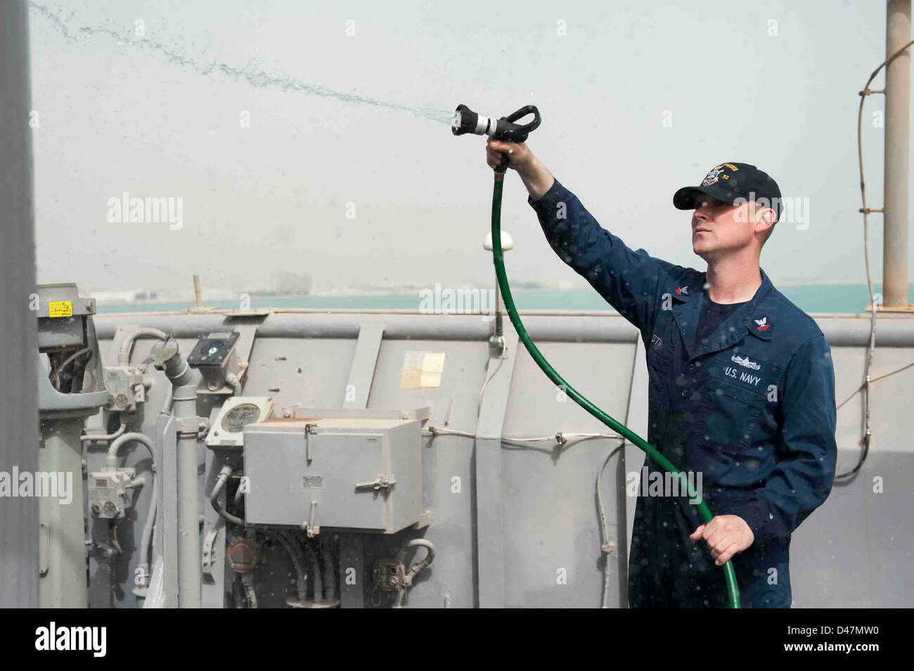 A U.S. Navy sailor participates in a freshwater wash down during ...
