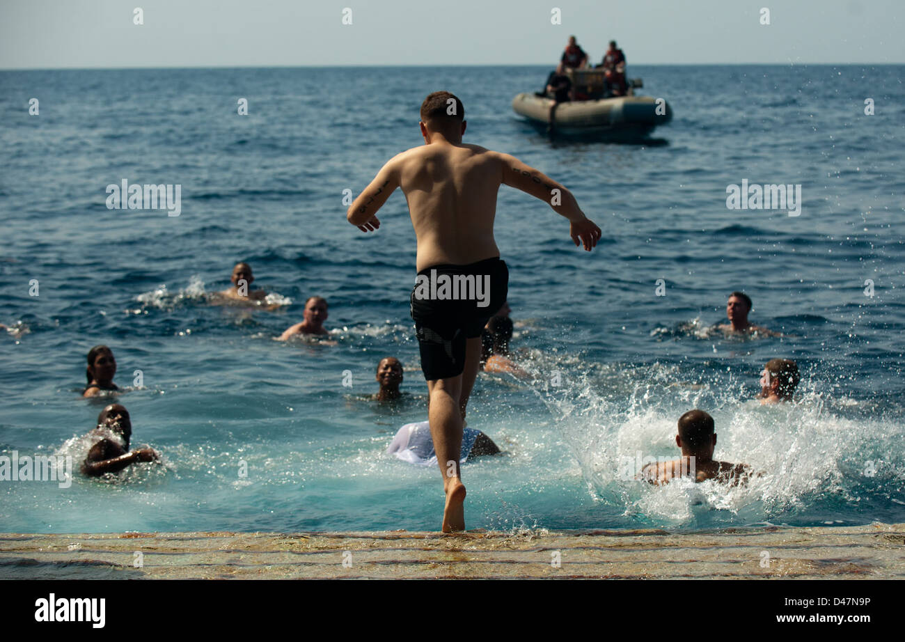 A Sailor aboard the USS New Orleans participates in a swim call while ...