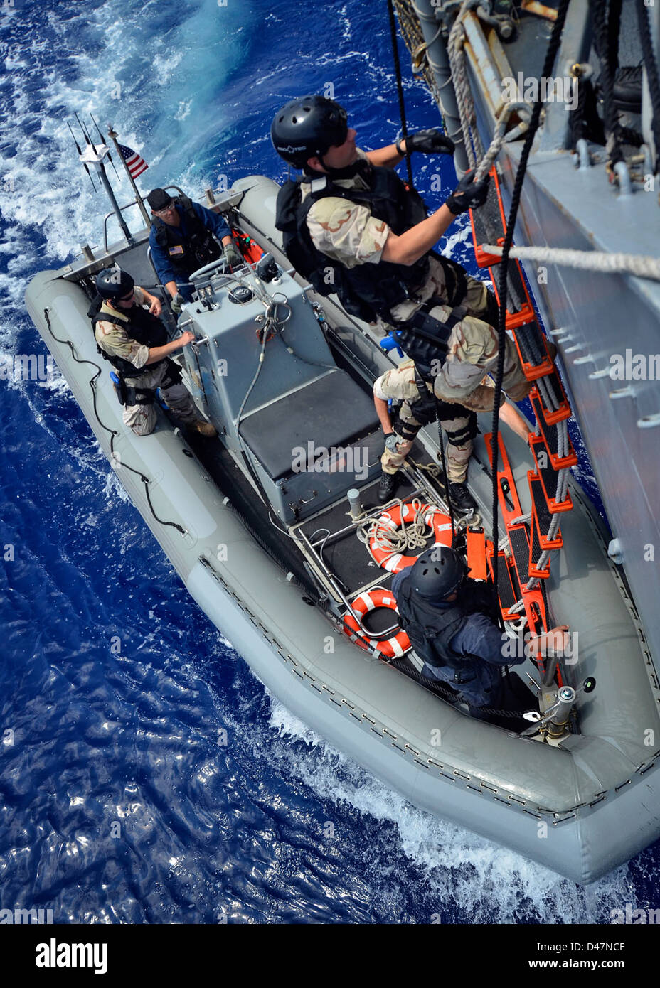 Members of the visit, board, search and seizure team prepare to ...