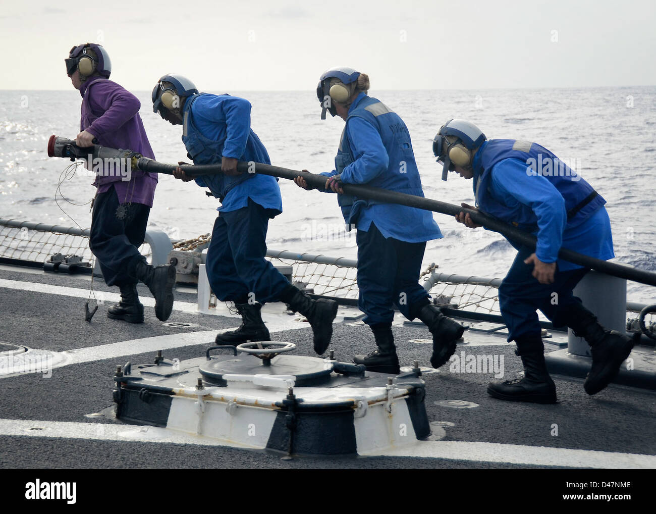 Sailors aboard the USS Paul Hamilton conduct a helicopter refueling ...