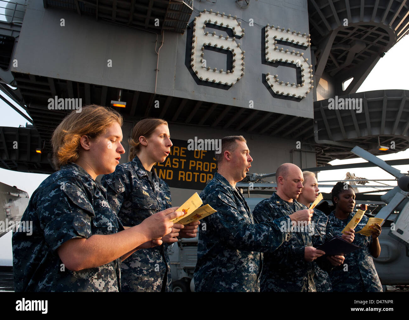 Sailors participate in Easter church services aboard a vessel in the ...