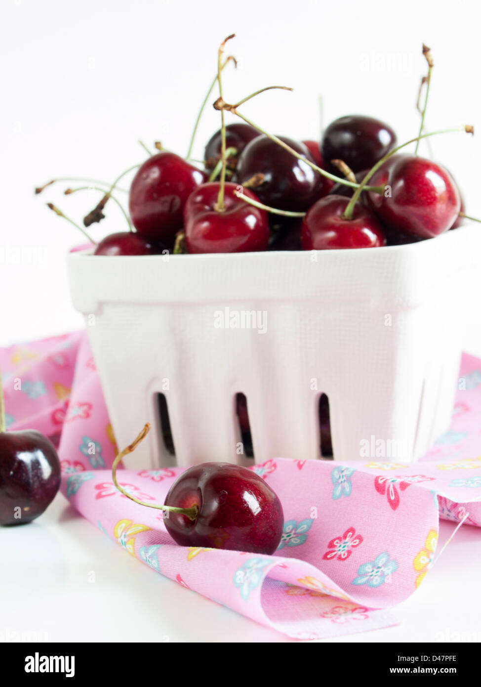 Freshly picked heap of cherries in white basket Stock Photo - Alamy