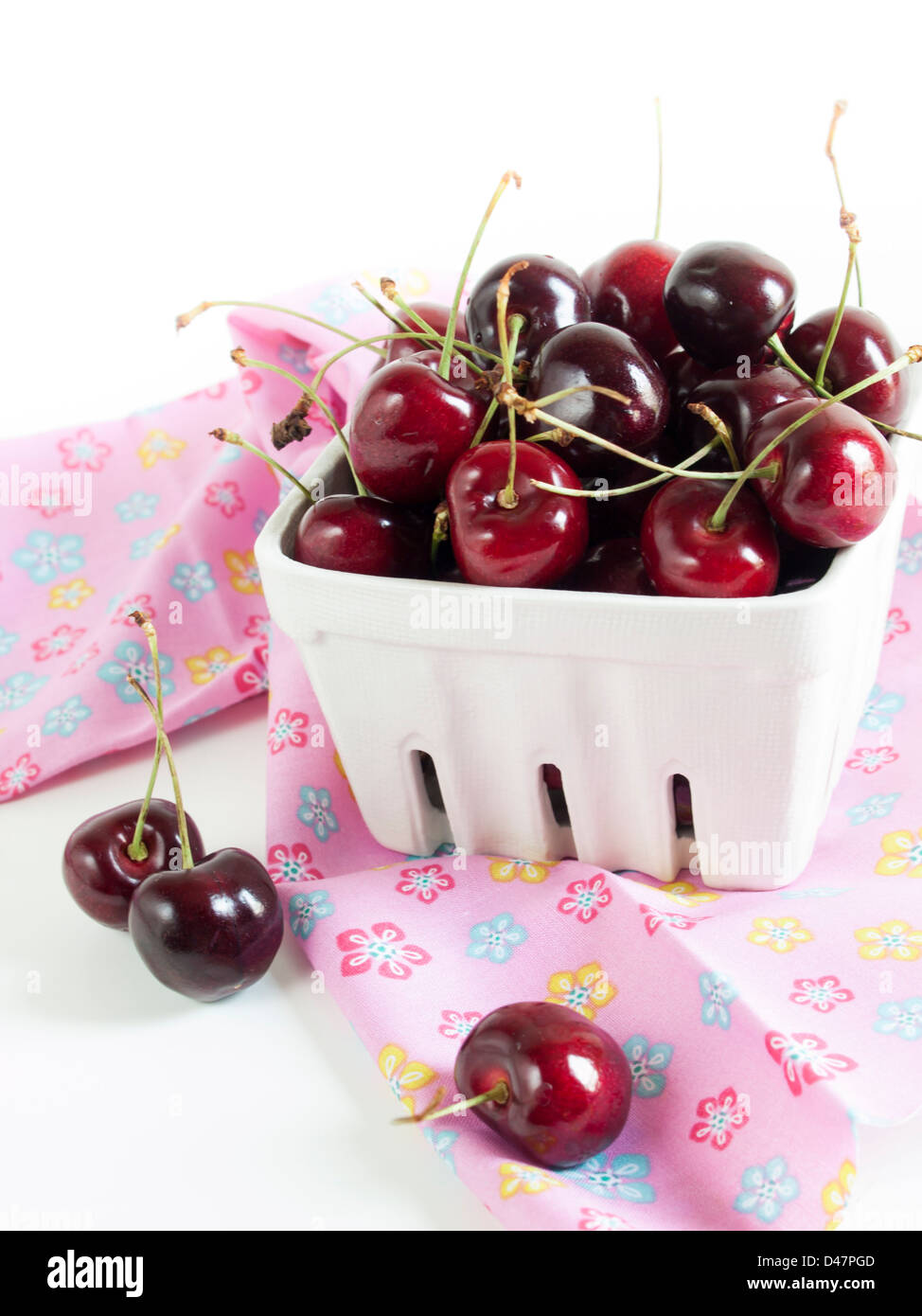 Freshly picked heap of cherries in white basket Stock Photo - Alamy