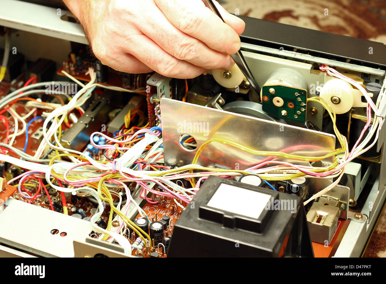 Hands repairing device Stock Photo - Alamy