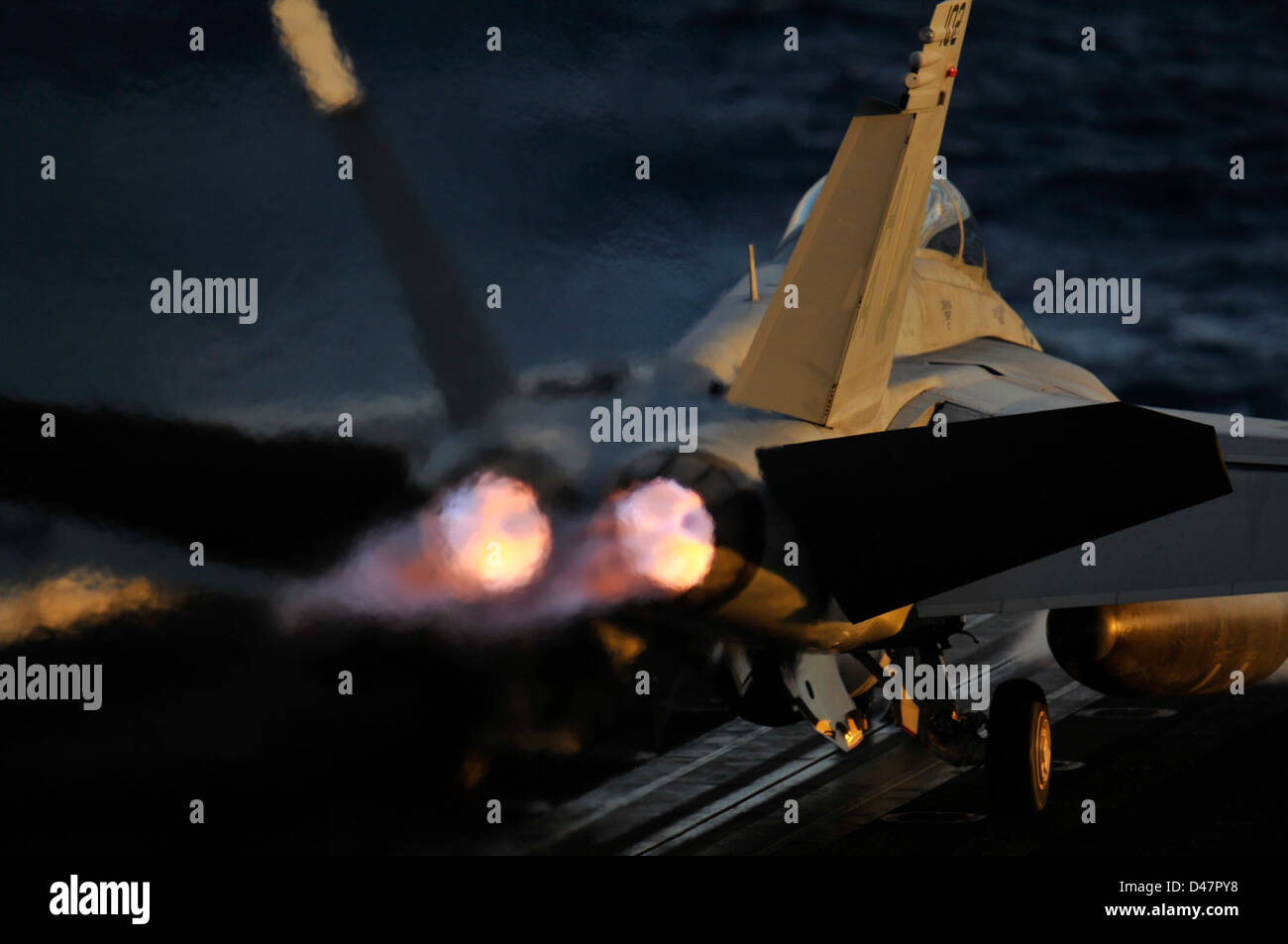 A jet launches from the flight deck of a U.S. Navy aircraft carrier ...