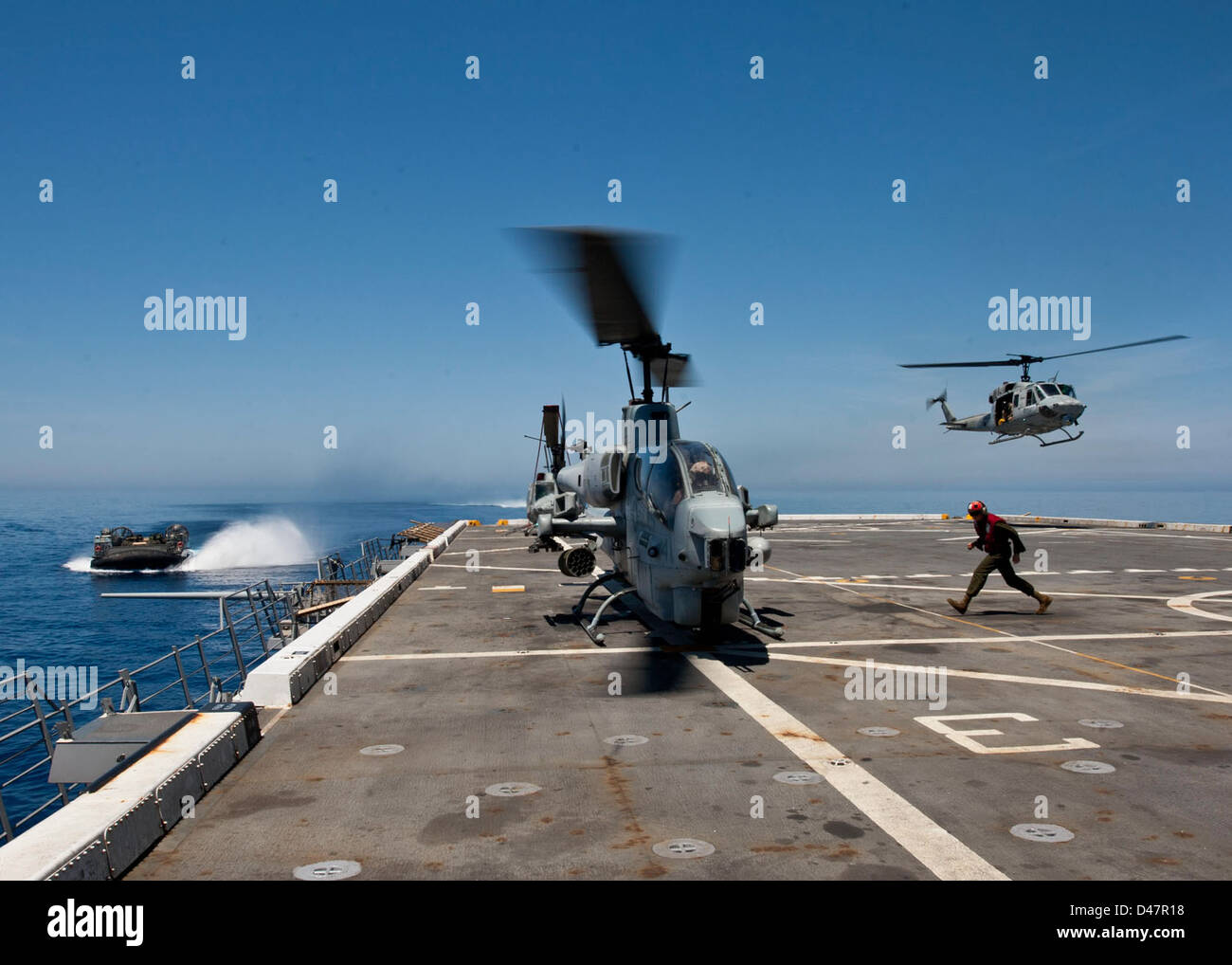 The USS New York conducts well deck and flight deck operations in the ...