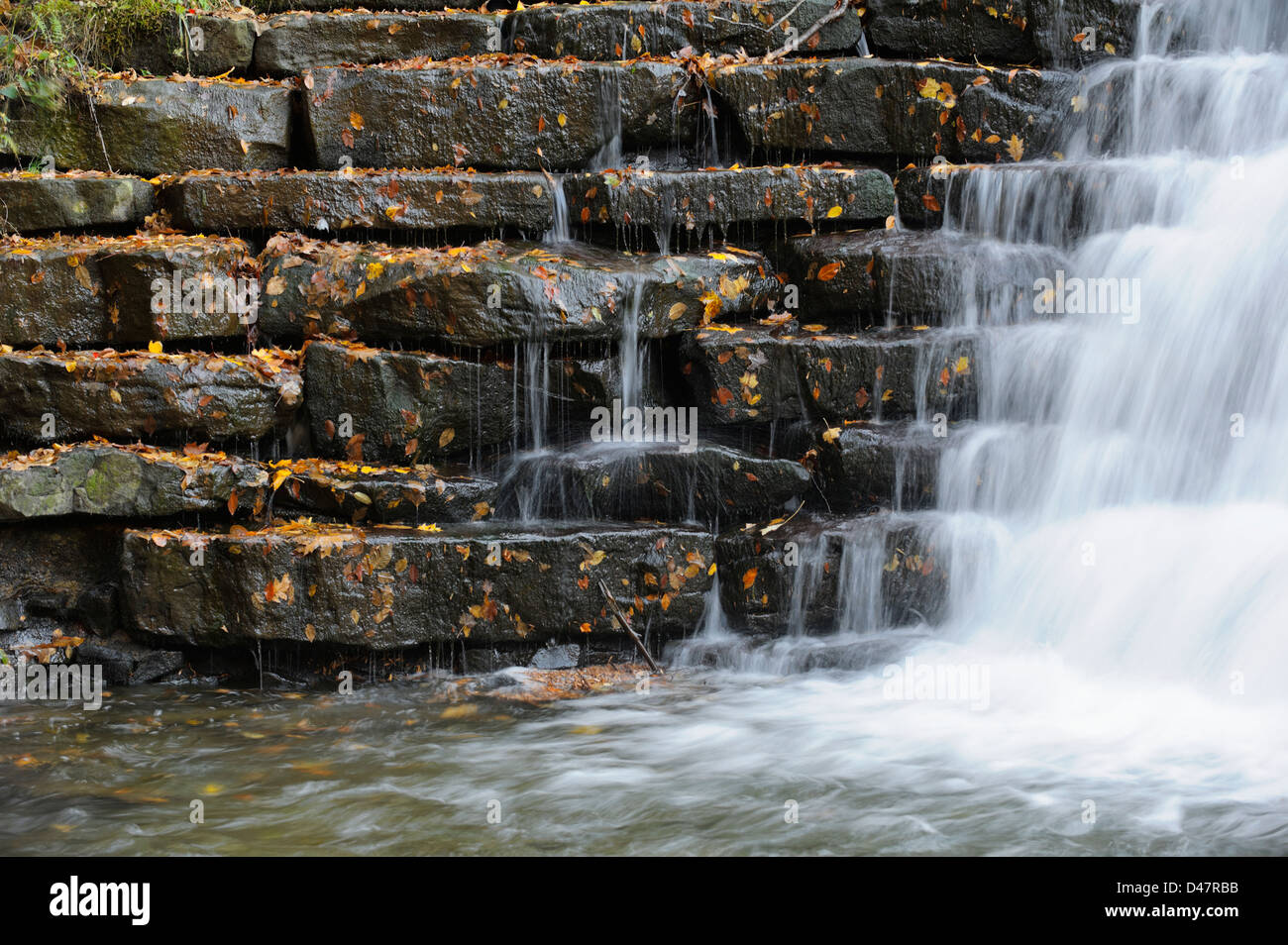 Waterfall flowing over even spaced rock steps Stock Photo - Alamy