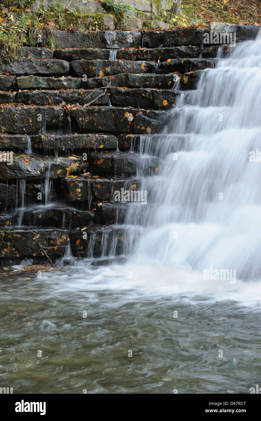 Waterfall flowing over evenly spaced rock steps Stock Photo - Alamy