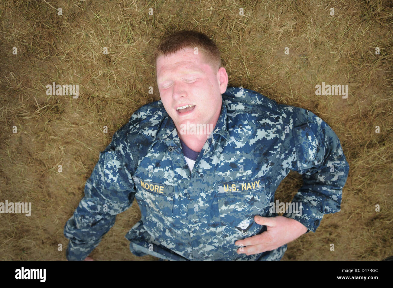 A first-year midshipman (plebe) rests after completing the ground ...