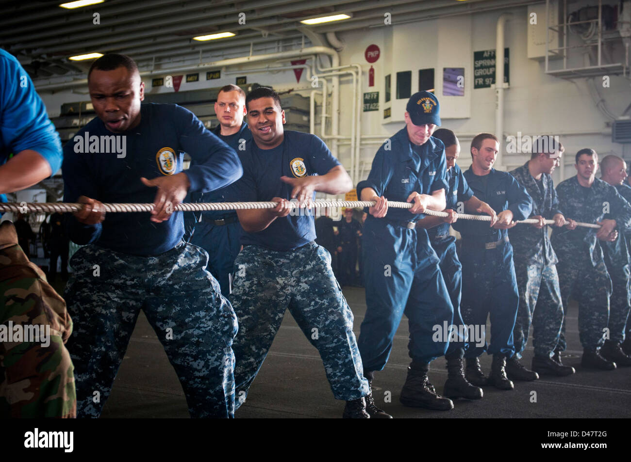 Sailors participate in a receiving line aboard a Navy ship in the ...