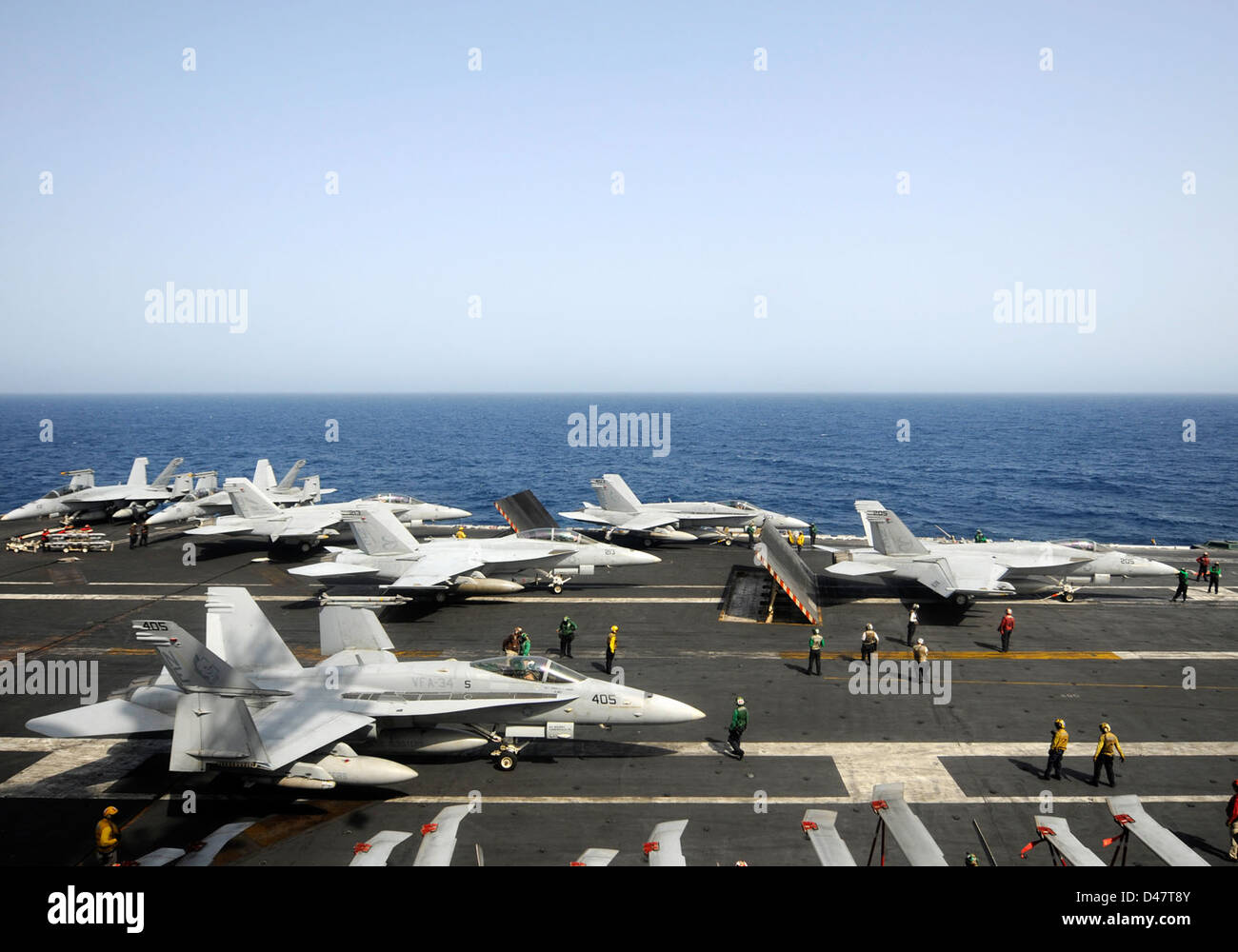 Aircraft line up for takeoff on the flight deck of USS Abraham Lincoln ...