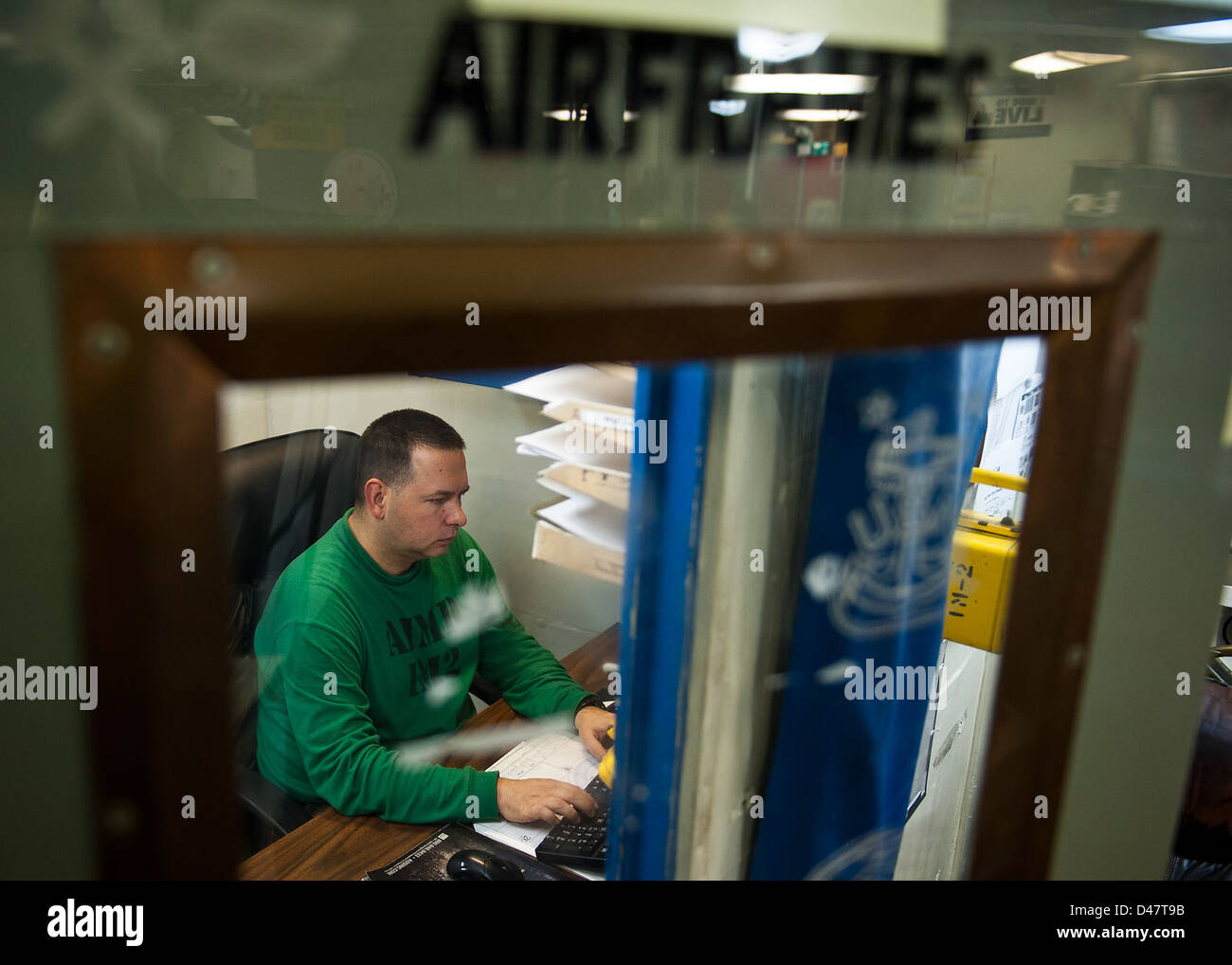 A Sailor updates the aircraft workload status in the jet shop aboard ...