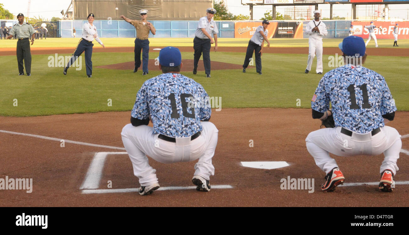 Service members from each branch of the military throw the first pitch ...