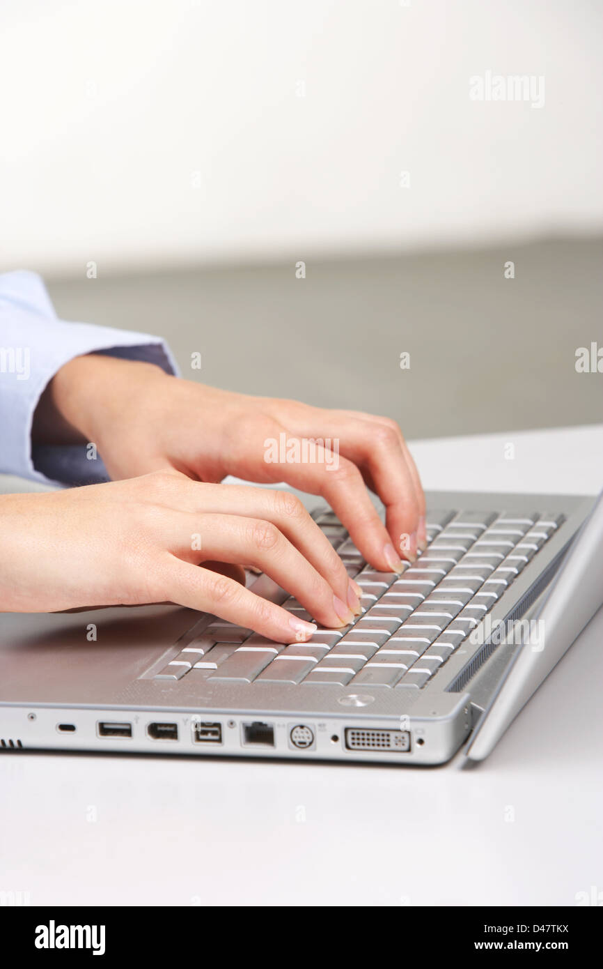 A person typing on a laptop keyboard Stock Photo - Alamy