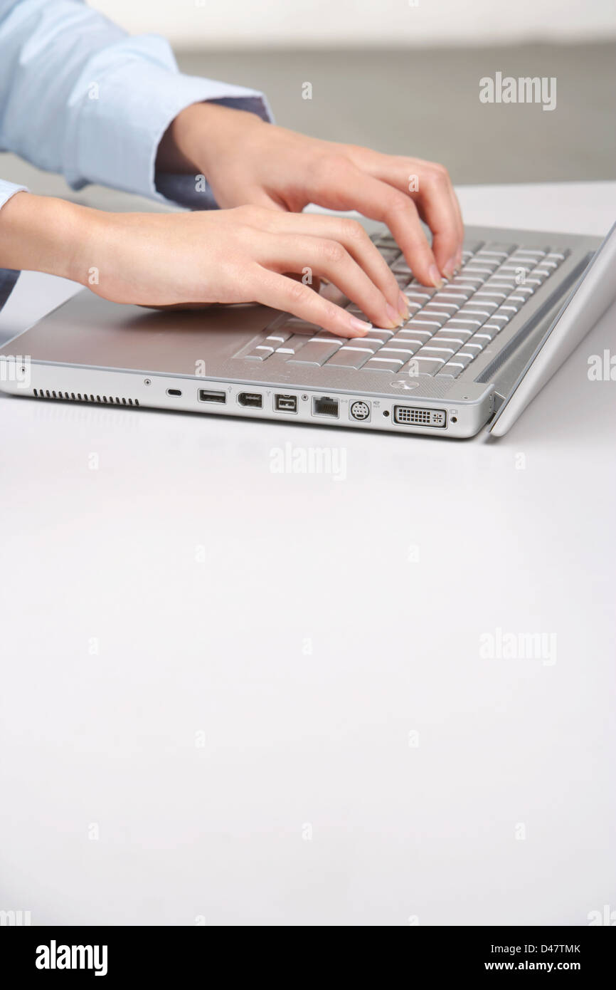 A person typing on a laptop keyboard Stock Photo - Alamy