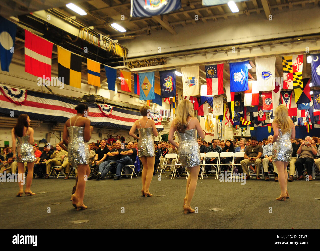 Sailors and Marines aboard the USS Wasp enjoy a USO performance by the ...