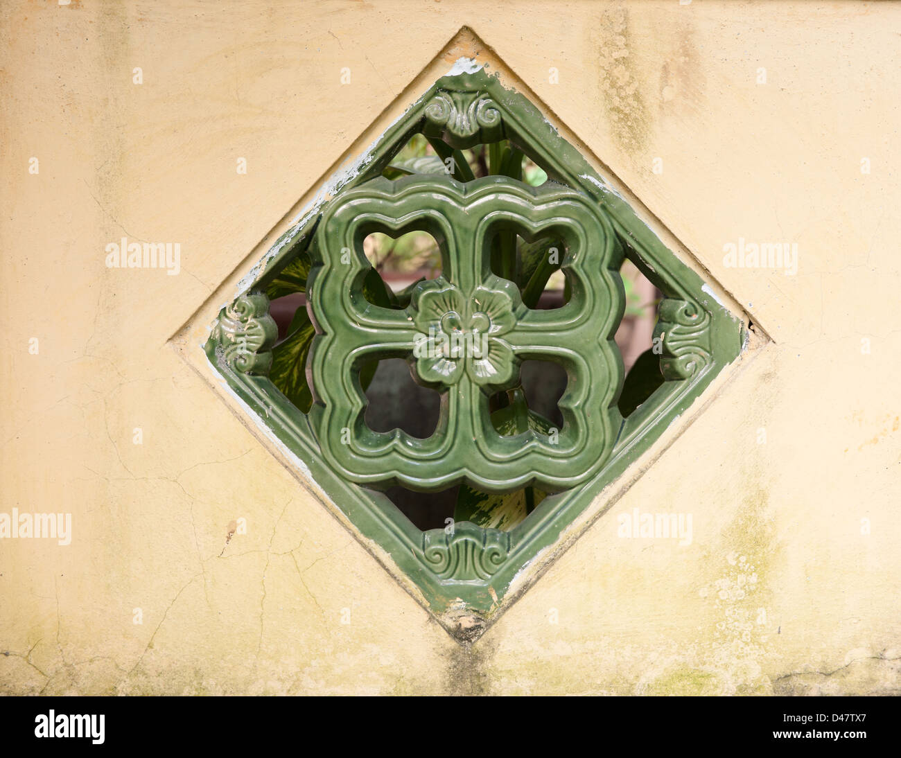 an ornamental window in old wall background Stock Photo - Alamy