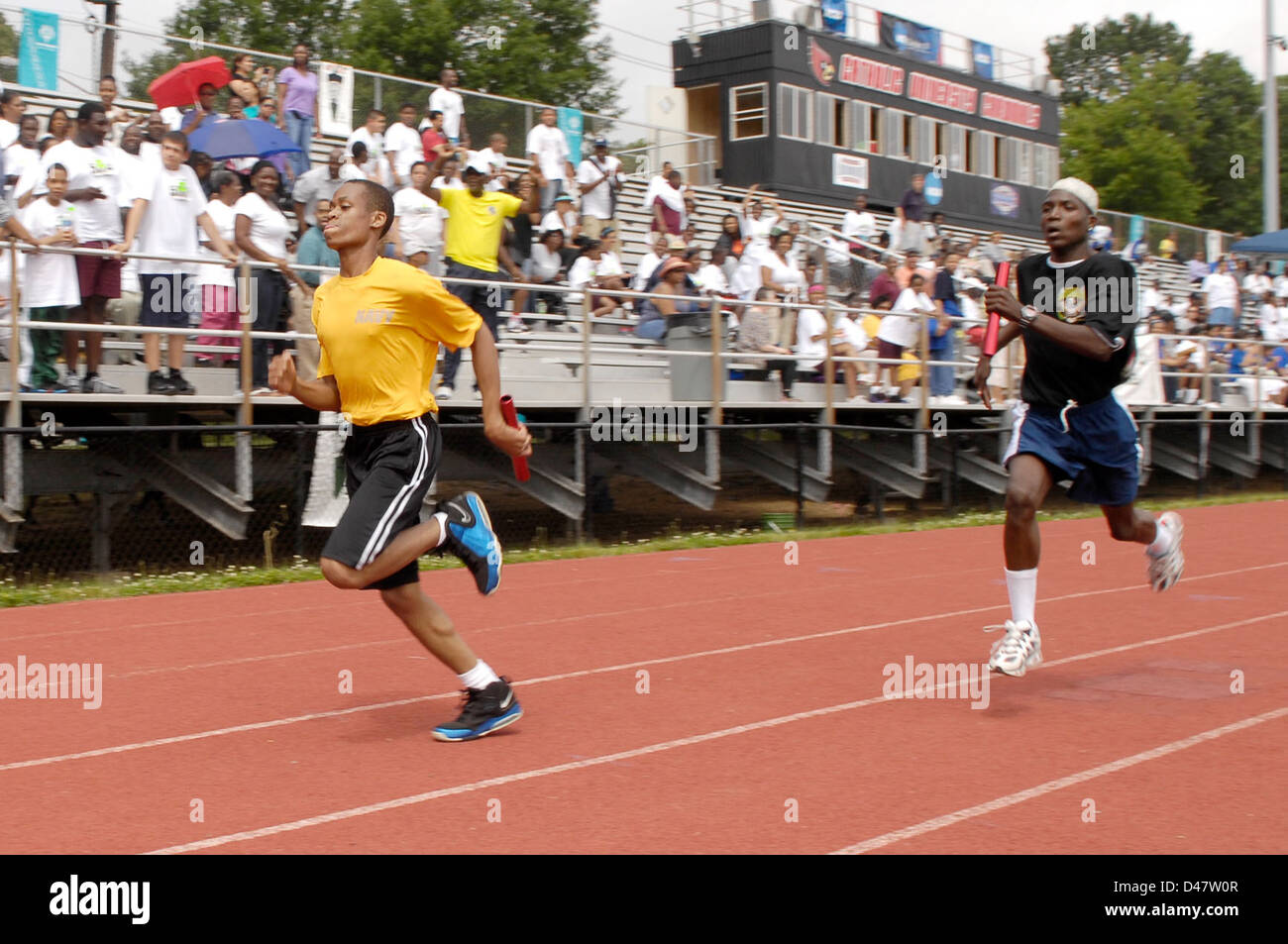 U.S. Navy and Army representatives run in the 4x100 meter relay race at ...