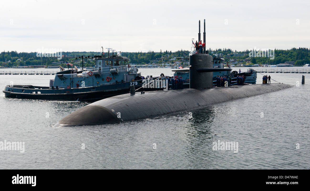 Sailors aboard the USS Bremerton (SSN 698) stand by as the submarine ...