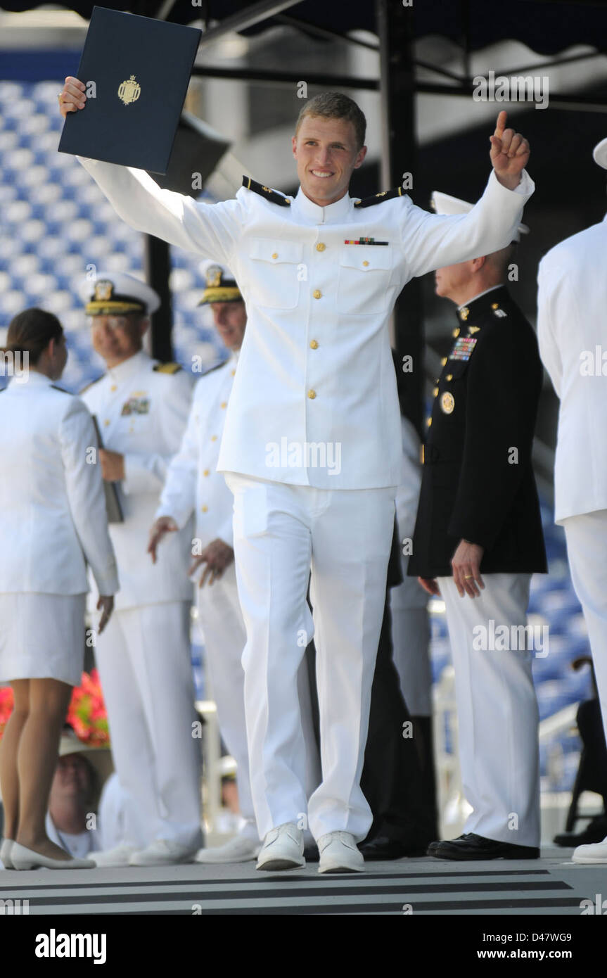 A midshipman from the U.S. Naval Academy receives their diploma during ...
