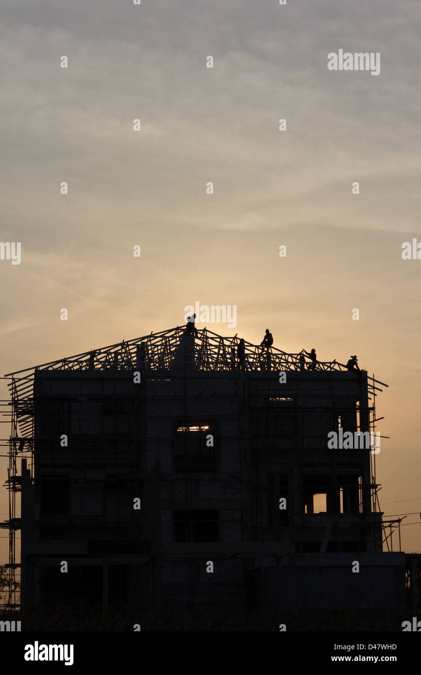 worker on construction site at sunset Stock Photo - Alamy