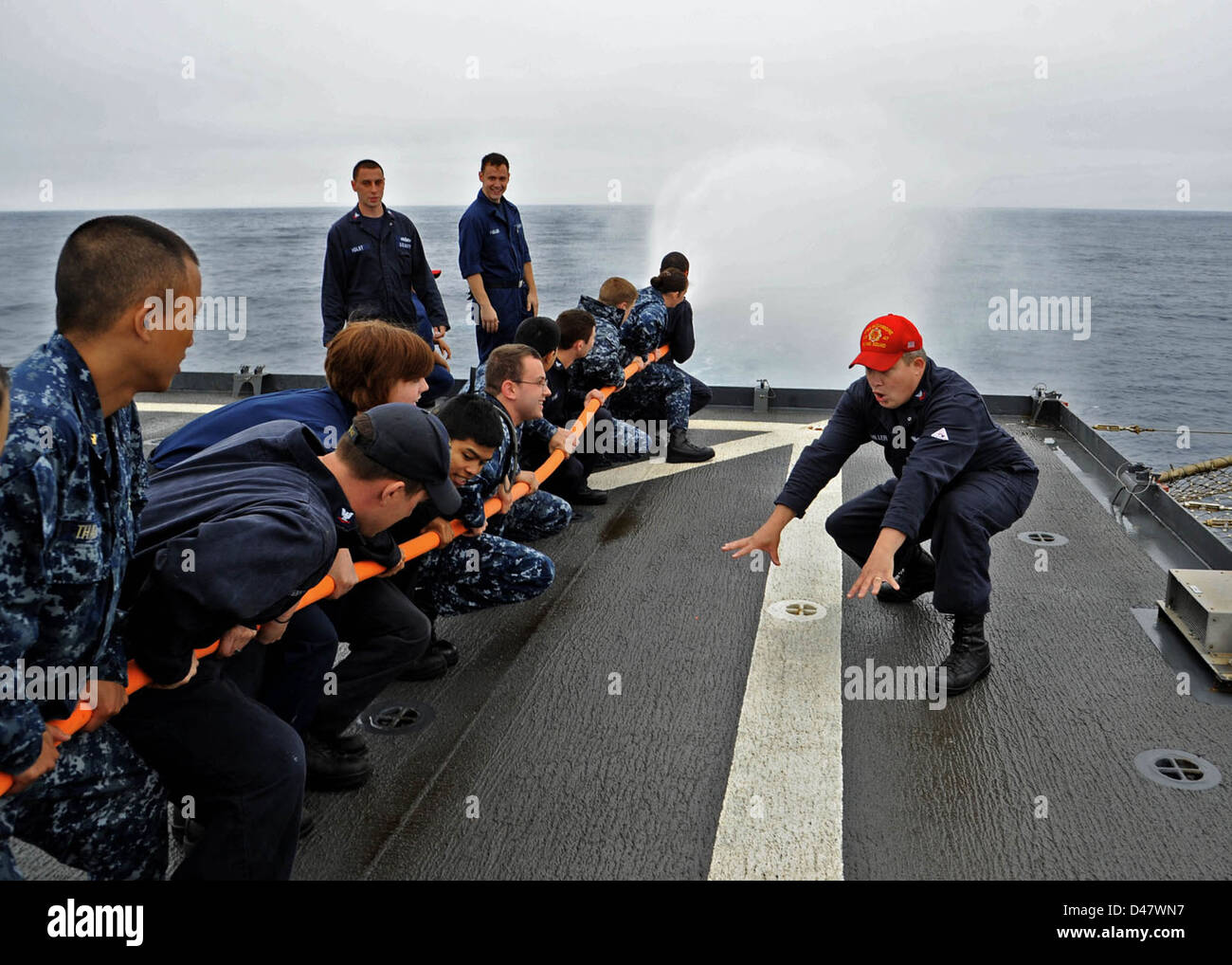 Sailors aboard a U.S. Navy ship practice damage control techniques ...