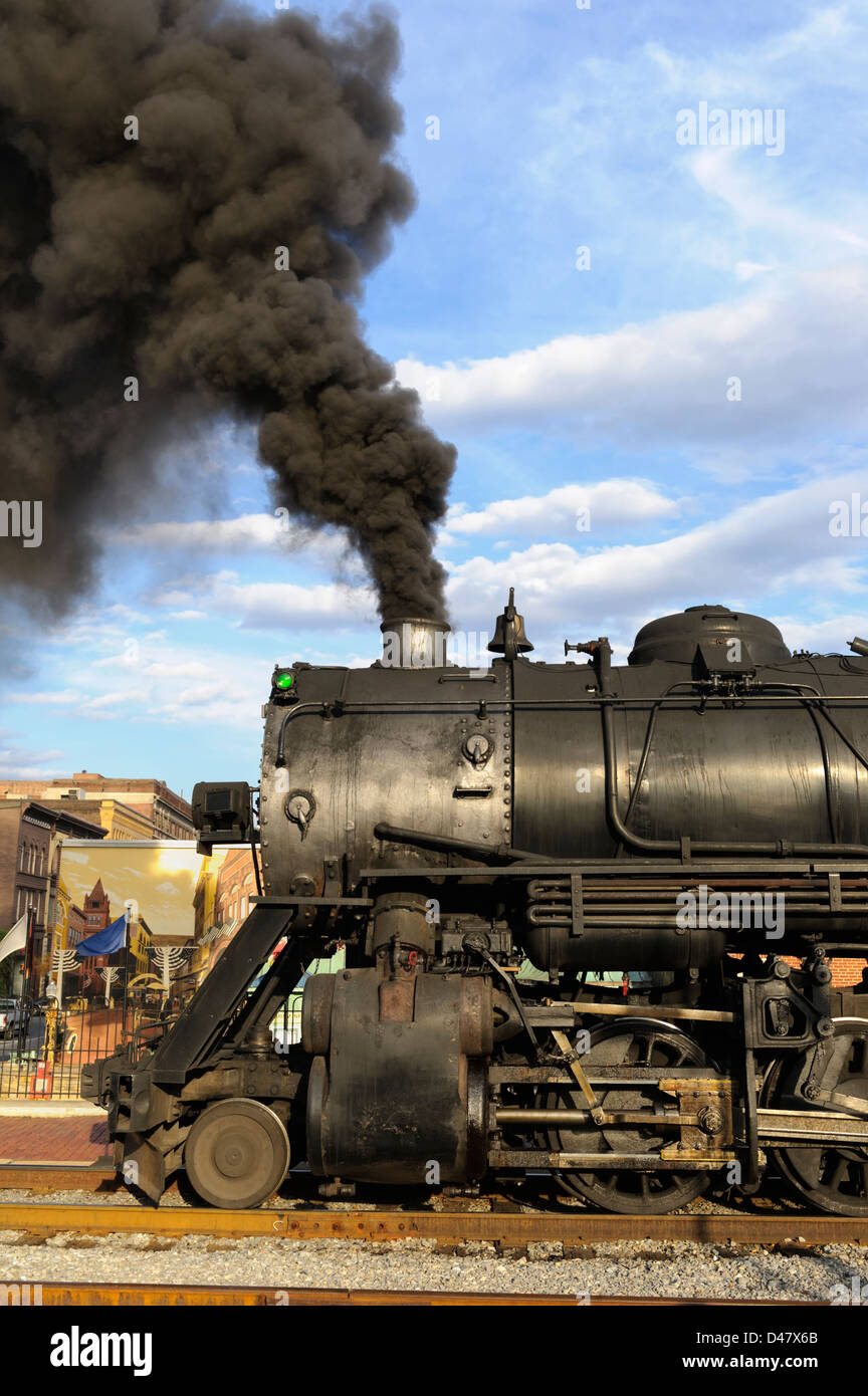 Steam locomotive making black smoke while stopped, side view in ...