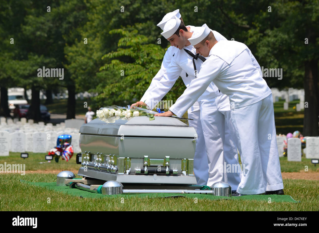 Sailors place their badges on the casket of Master at Arms 2nd Class ...