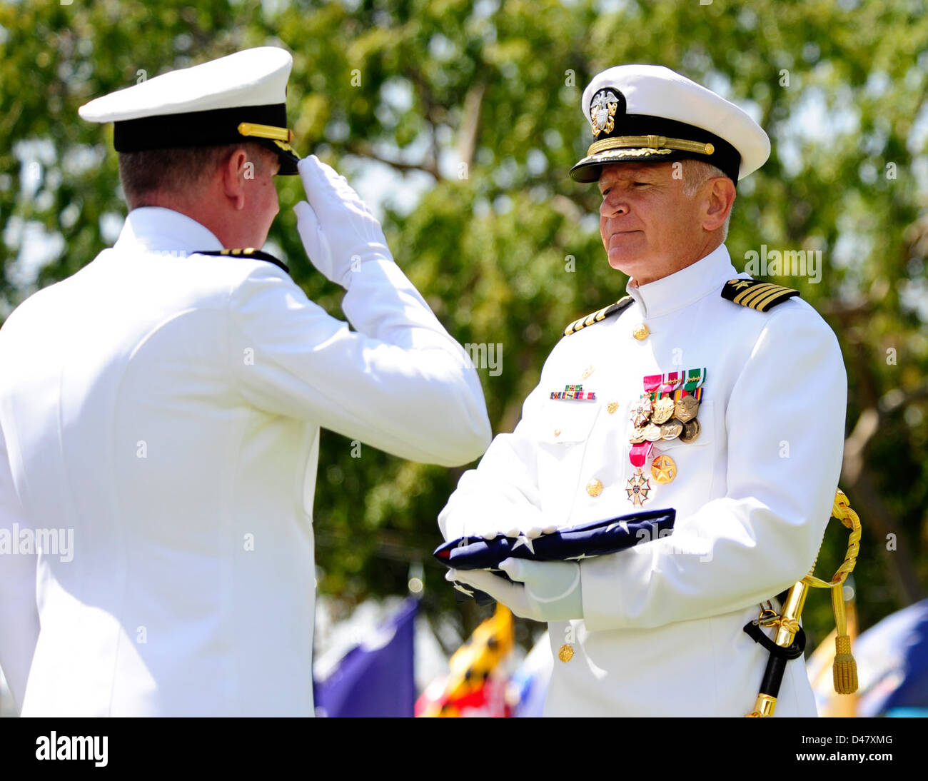 A Navy Captain receives a flag during a change of command ceremony at Naval Weapons Station Seal ...