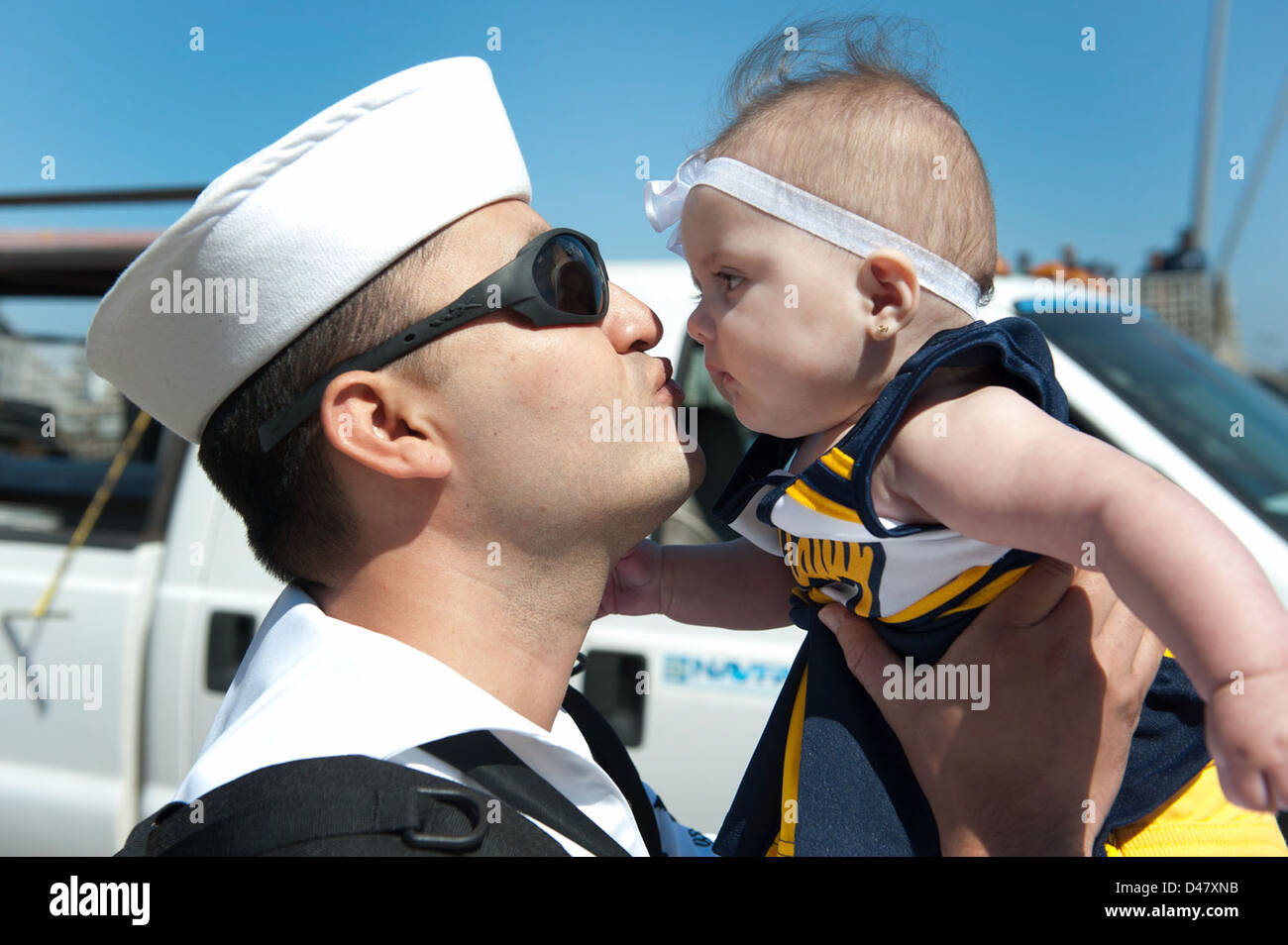 A Sailor greets his newborn child after returning Stock Photo - Alamy