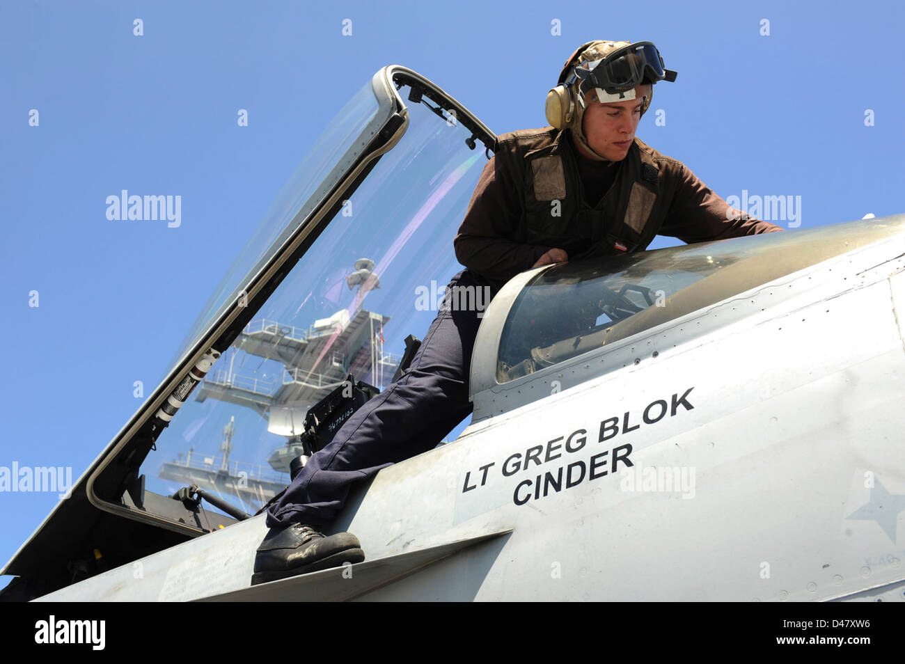 A Sailor aboard a U.S. Navy ship in the Pacific Ocean cleans the ...