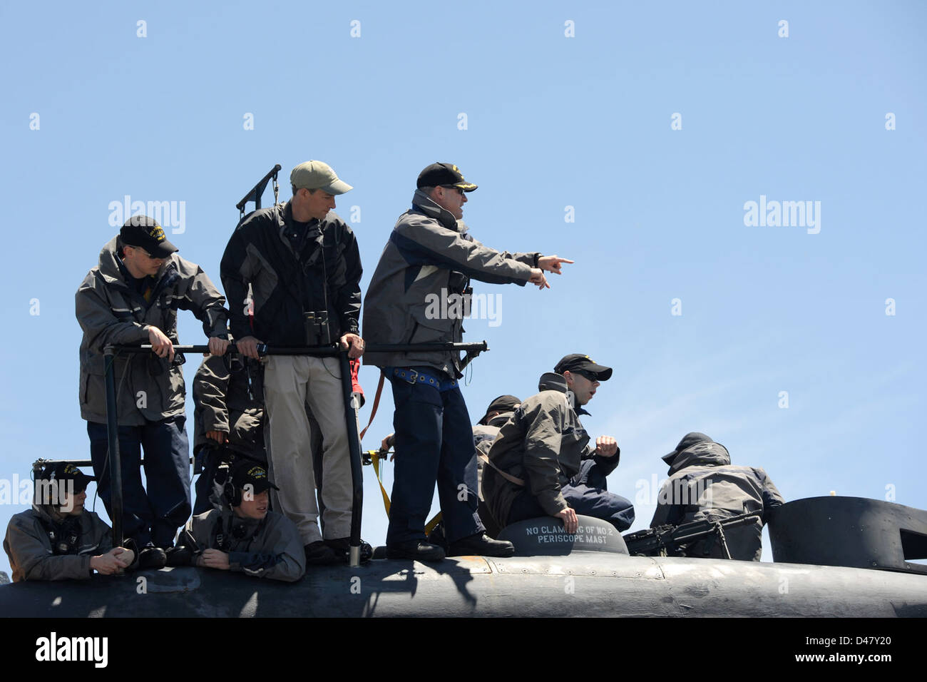 The Commanding Officer of the USS Pittsburgh provides instructions to ...